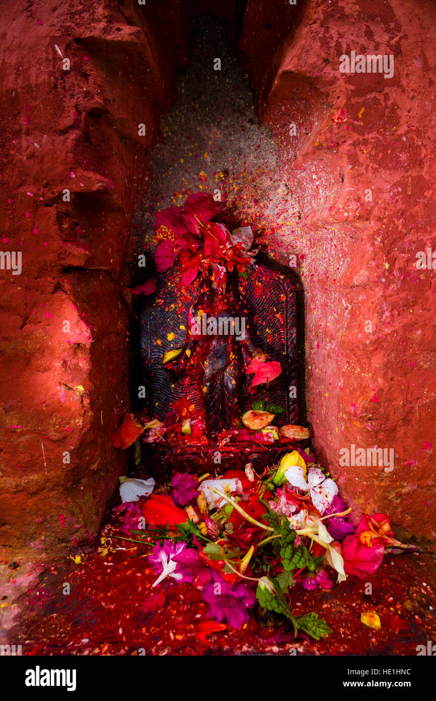 A small statue of the god Brahma Sharini is colorfully decorated ...