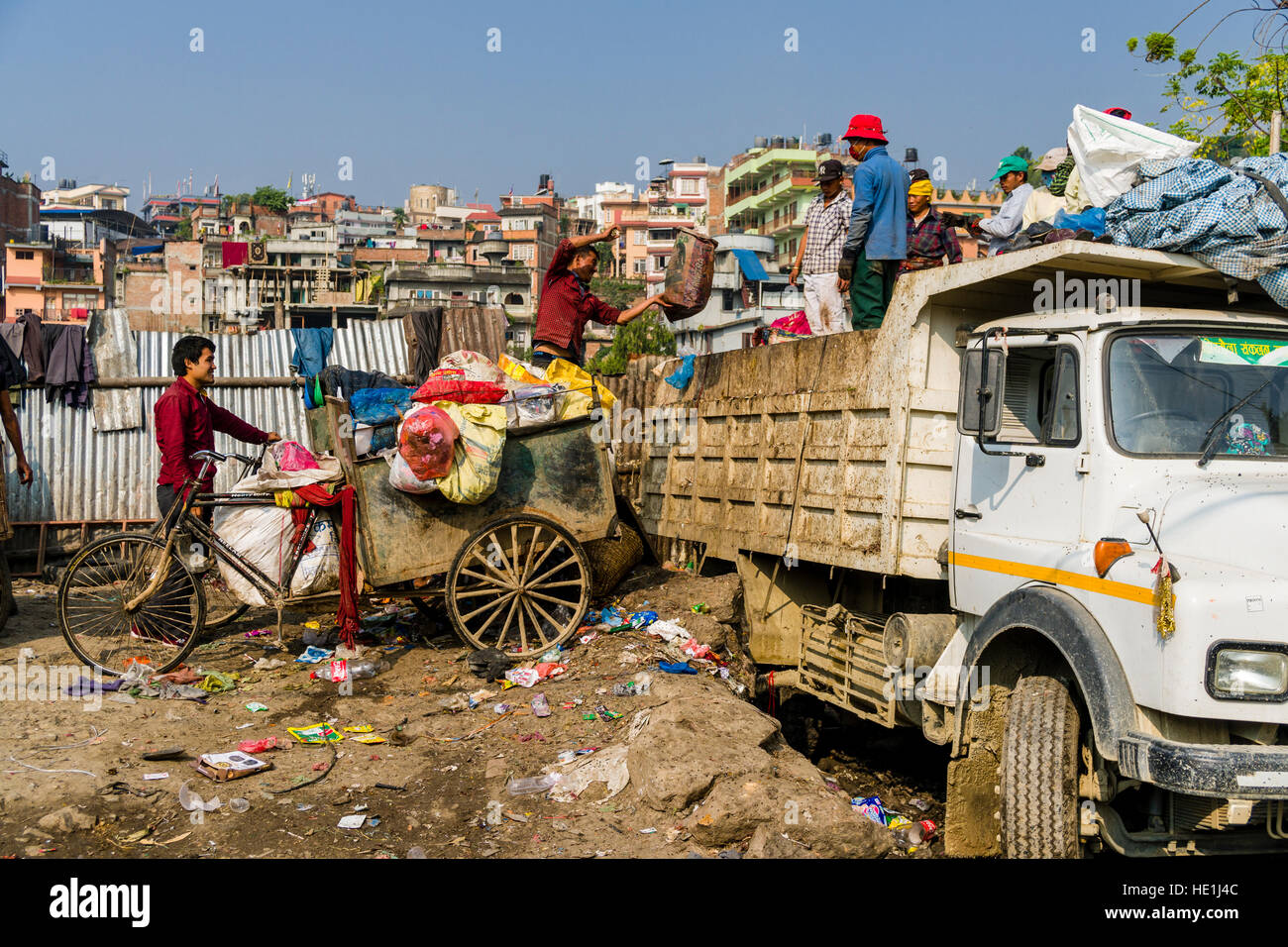 People are collecting garbage in the city, loading it on trucks and ...