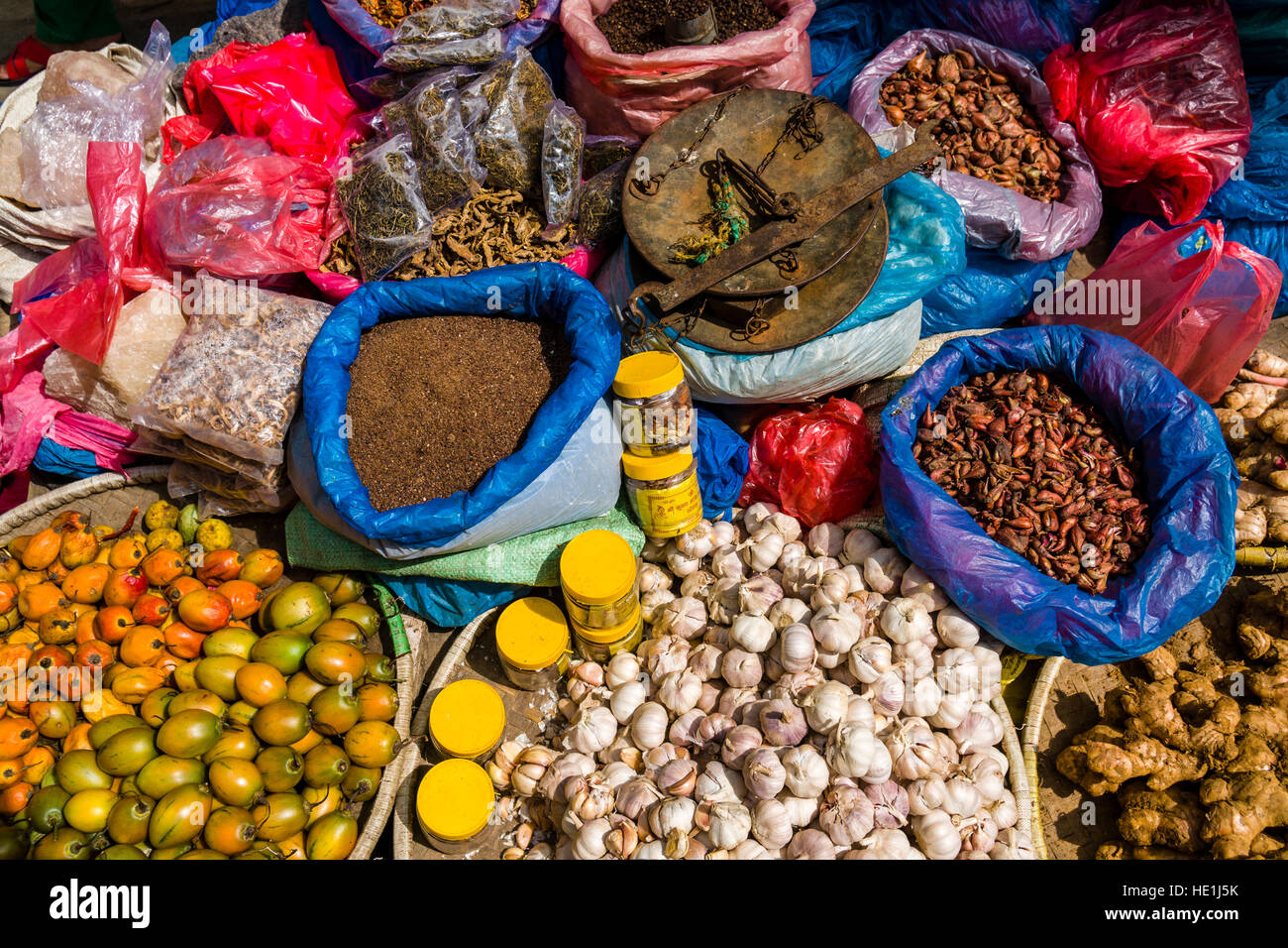 Different spices, garlic, tomatoes and ginger are sold in the street ...