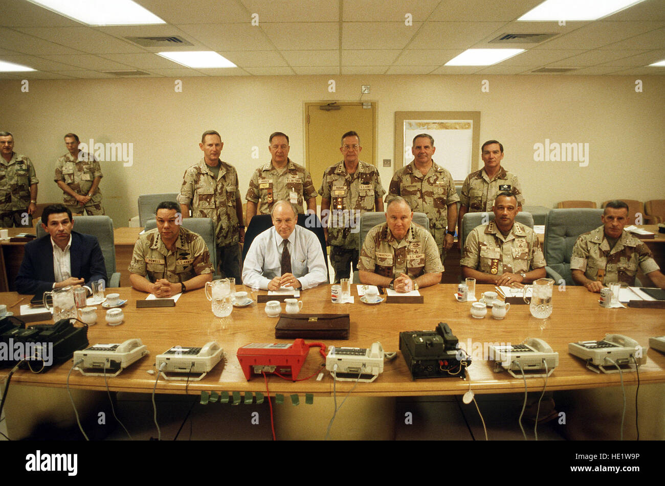Civilian and military officials pose for a group photograph prior to ...