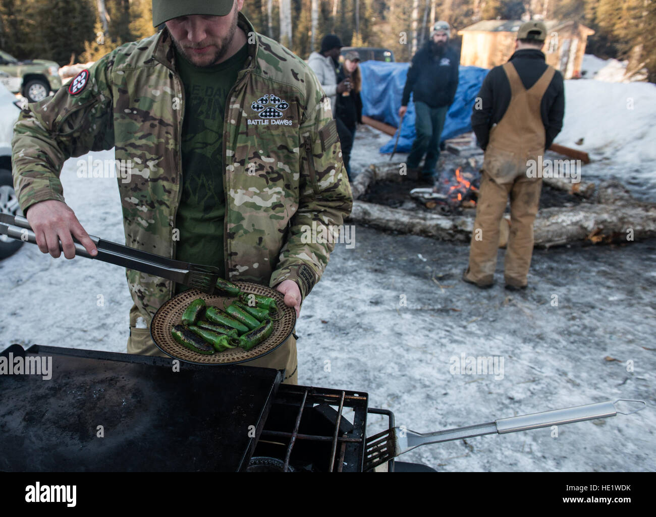 Jessy Lakin grills peppers during a BBQ at the Battle Dawgs kennel ...