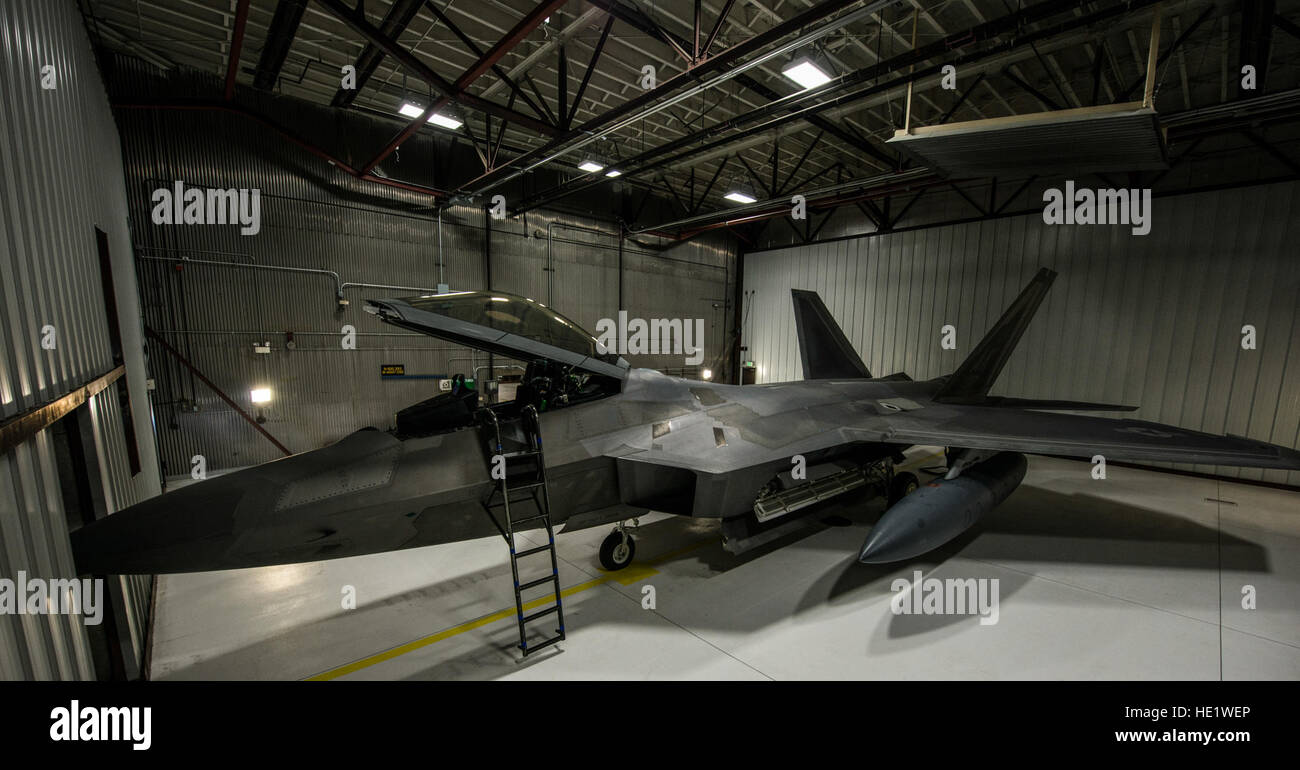 An F-22 Raptor sits ready to launch in a hangar at the Combat Alert ...