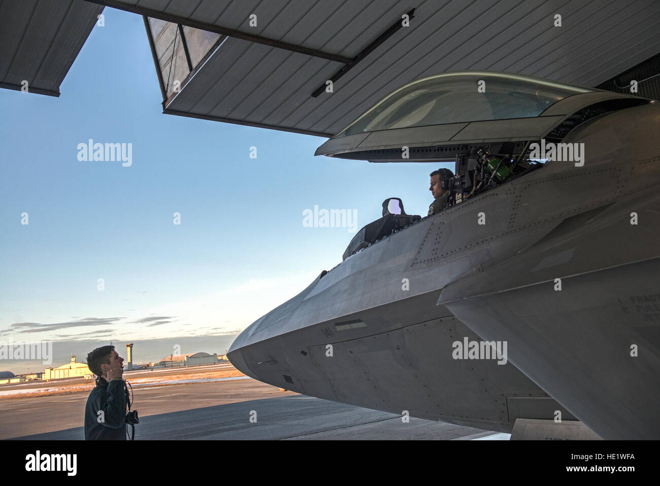 Senior Airman Christopher Sauter talks with Capt. Dustin Hardwick as ...