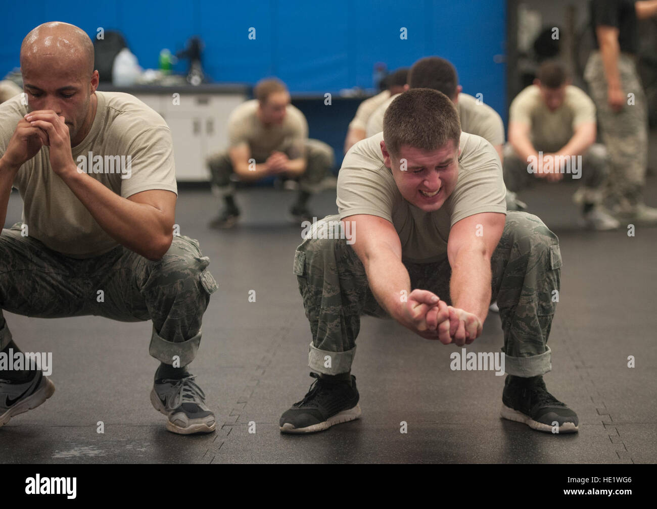 Security Forces patrolmen, grimace as they perform squats during the ...