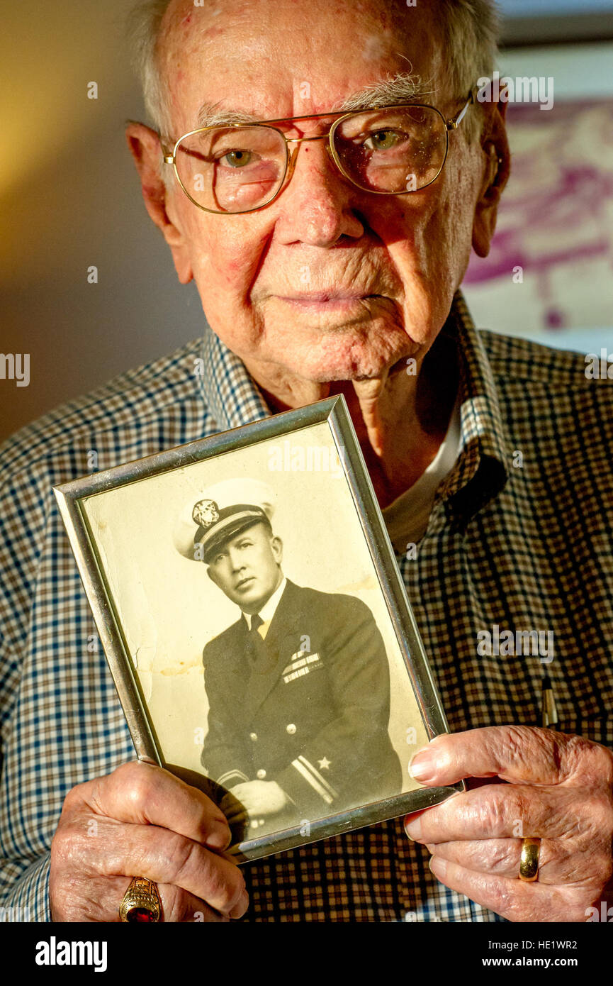 Frederick Austin Crow Jr., now 90, holds a photograph of his father ...