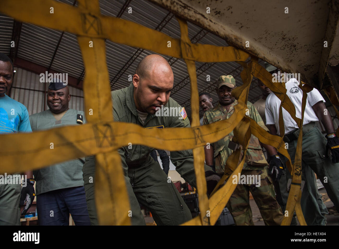 Staff Sgt. Dustin Franks shows students how to secure a cargo net ...