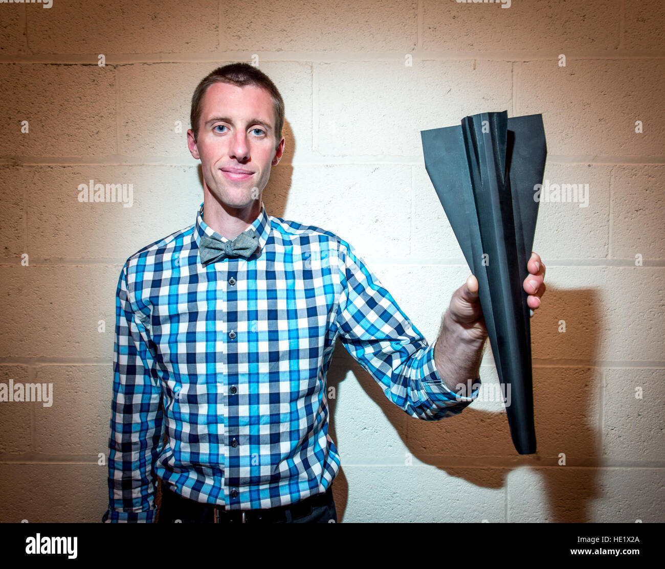 Ryan Helbach, a Hypersonic Research Engineer, holds a flight test model ...