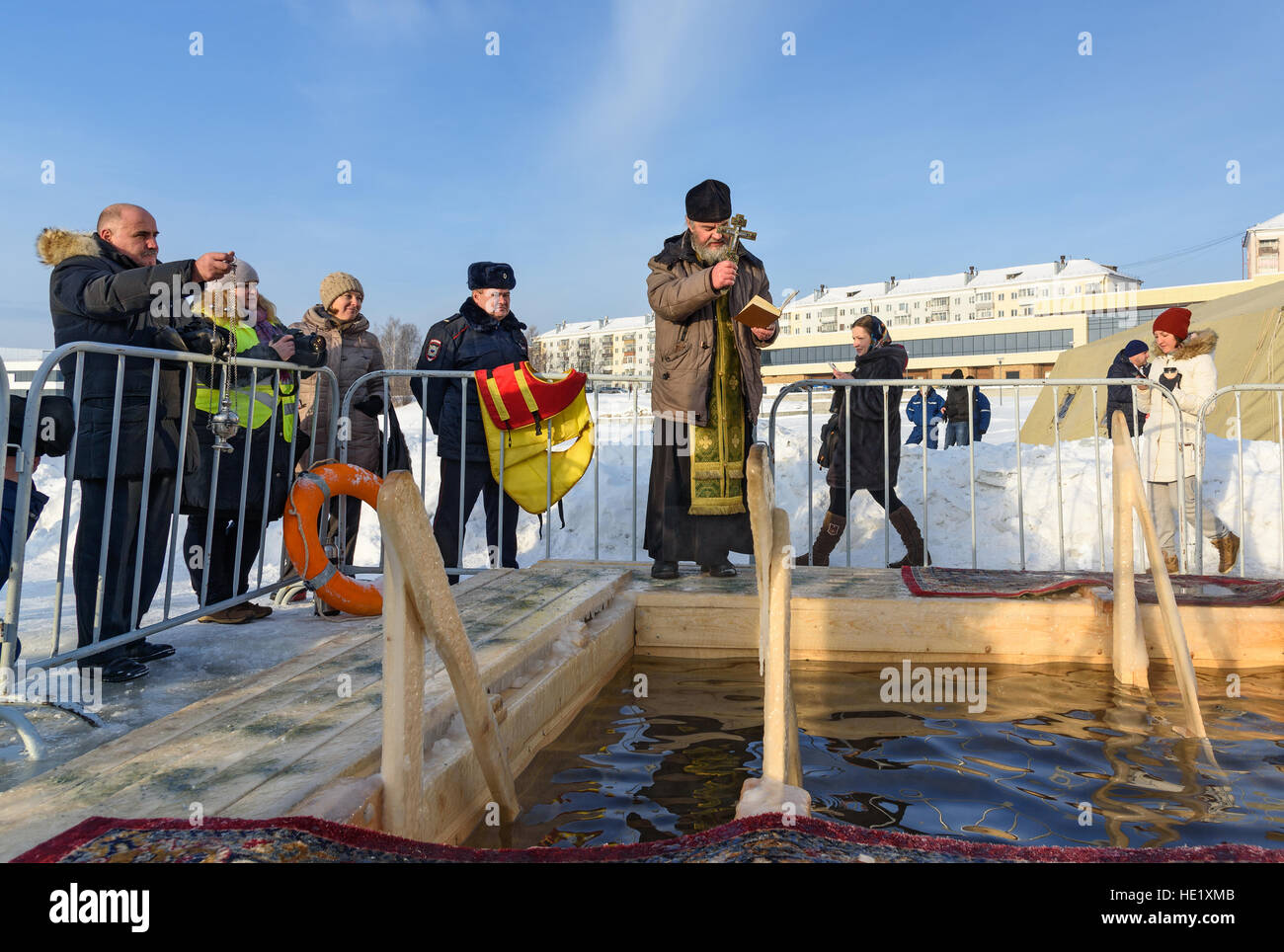 Priest consecrates the ice hole on Epiphany day. Traditional ice ...