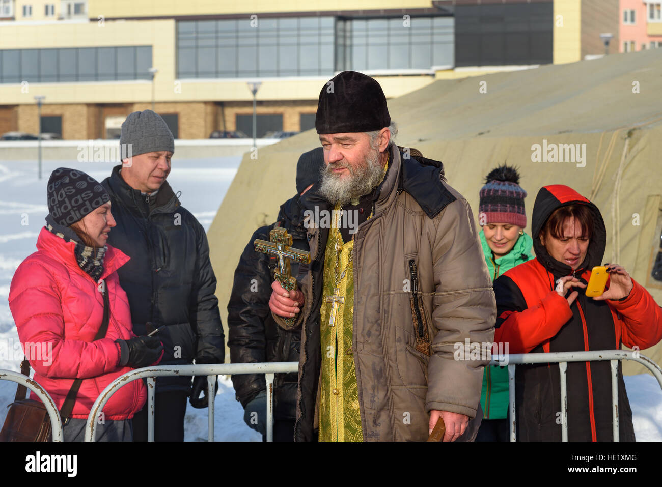 Priest consecrates the ice hole on Epiphany day. Traditional ice ...