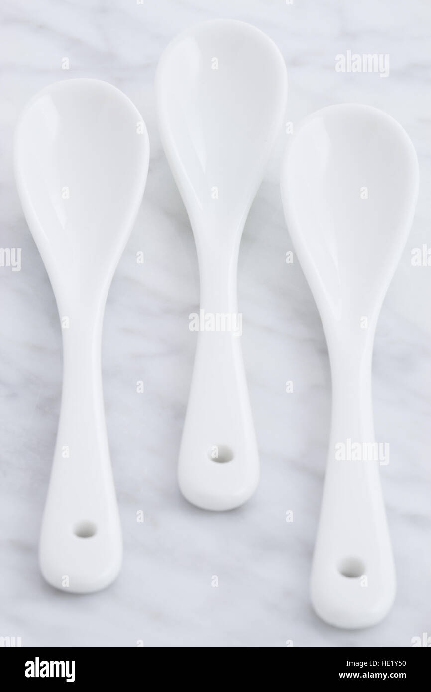 white spoon set styled on antique carrara marble Stock Photo - Alamy