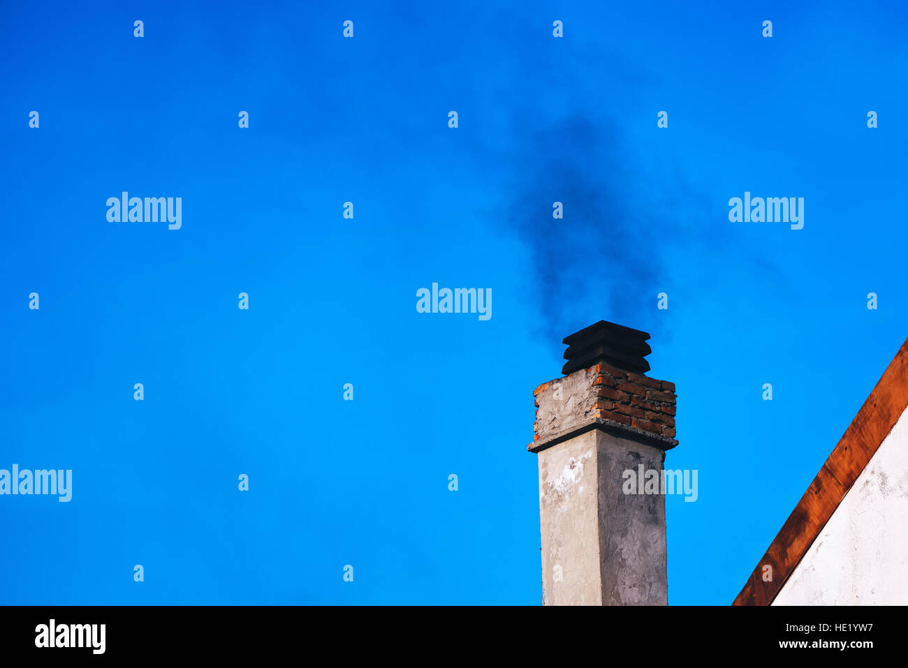 Smoke from house chimney on winter day Stock Photo - Alamy