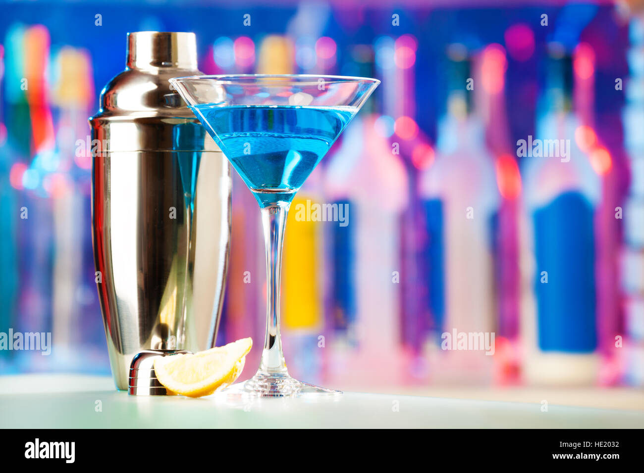 Martini glass and shaker standing on a bar counter Stock Photo - Alamy