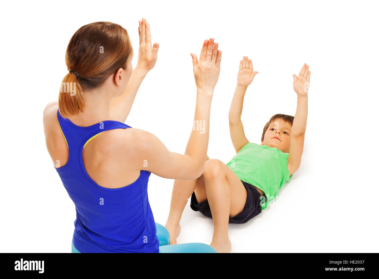 Kid boy repeating physical exercises after trainer Stock Photo - Alamy