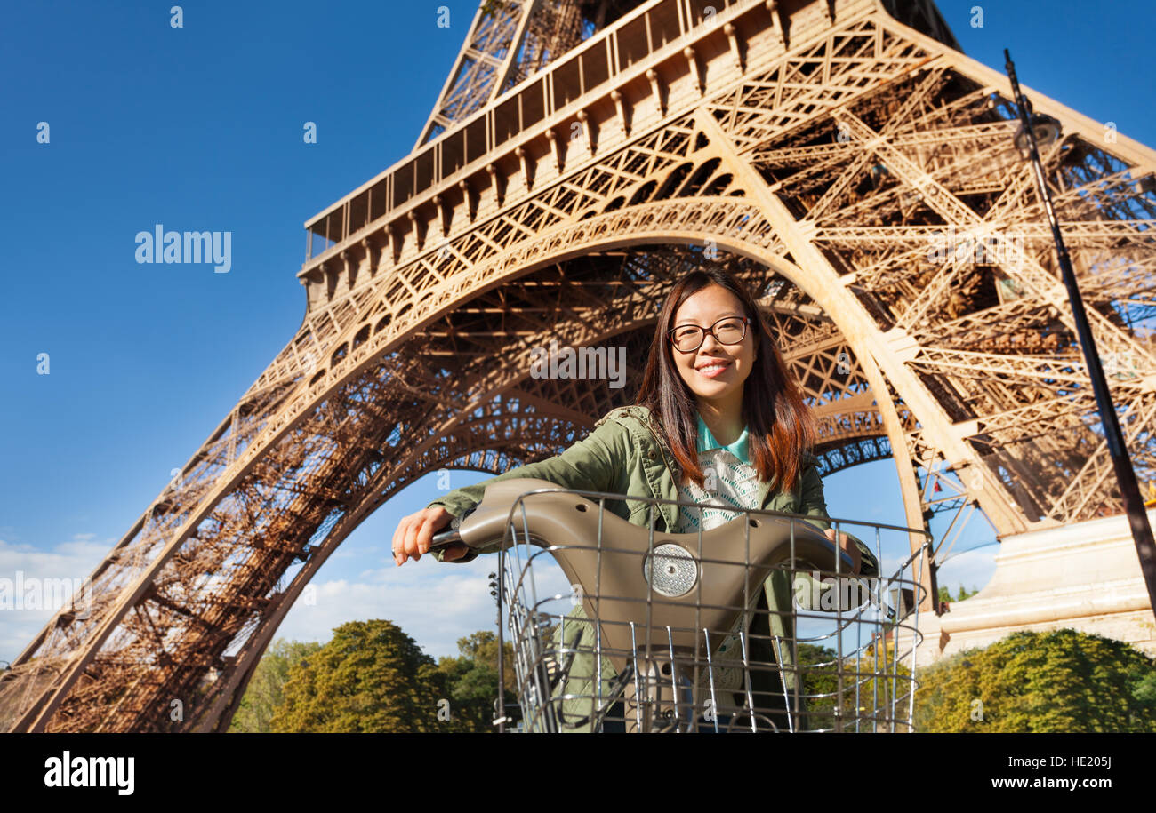 Pretty young woman riding bike near Eiffel Tower Stock Photo - Alamy