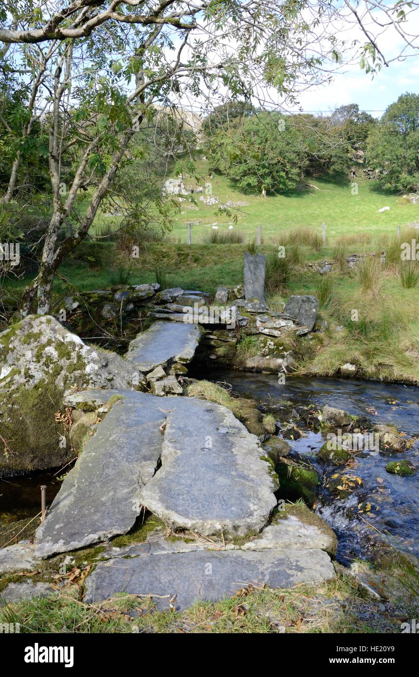 Old stone clapper bridge crossing Afon Croesor River Cwm Croesor Valley ...