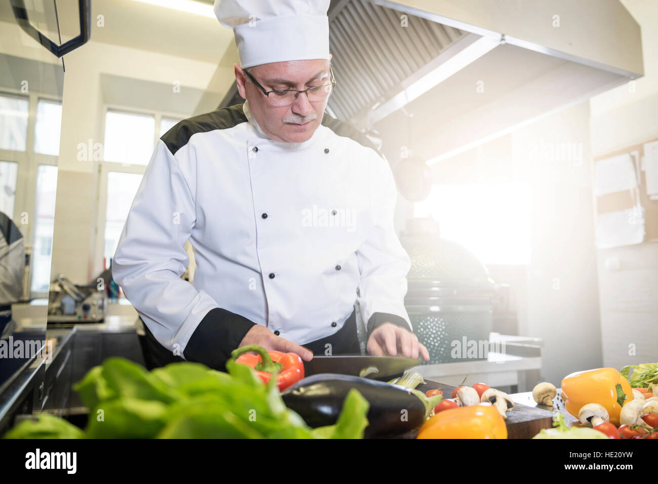 Adult chef chopping fresh vegetables Stock Photo - Alamy