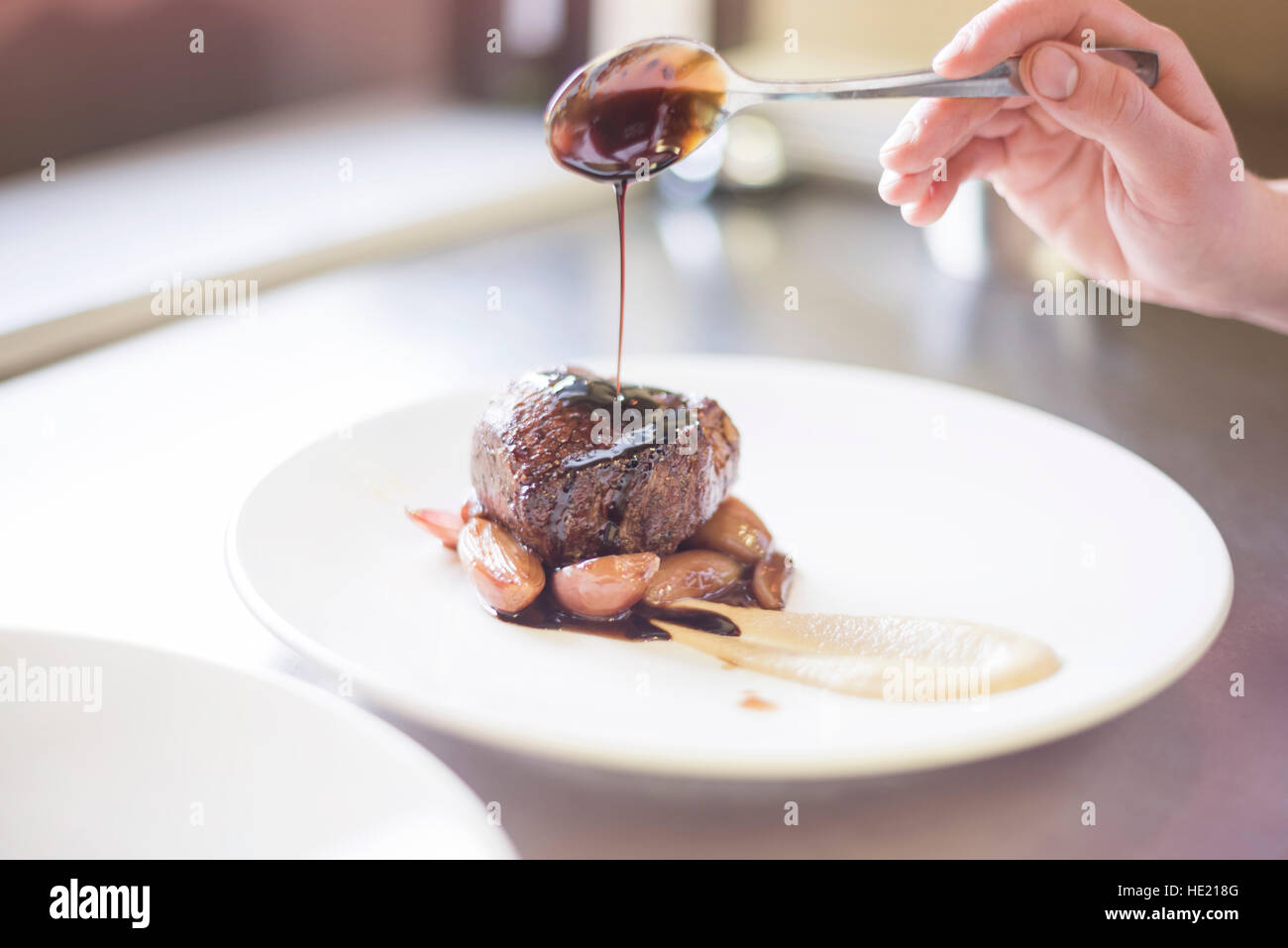 Chef finishing the main course Stock Photo - Alamy