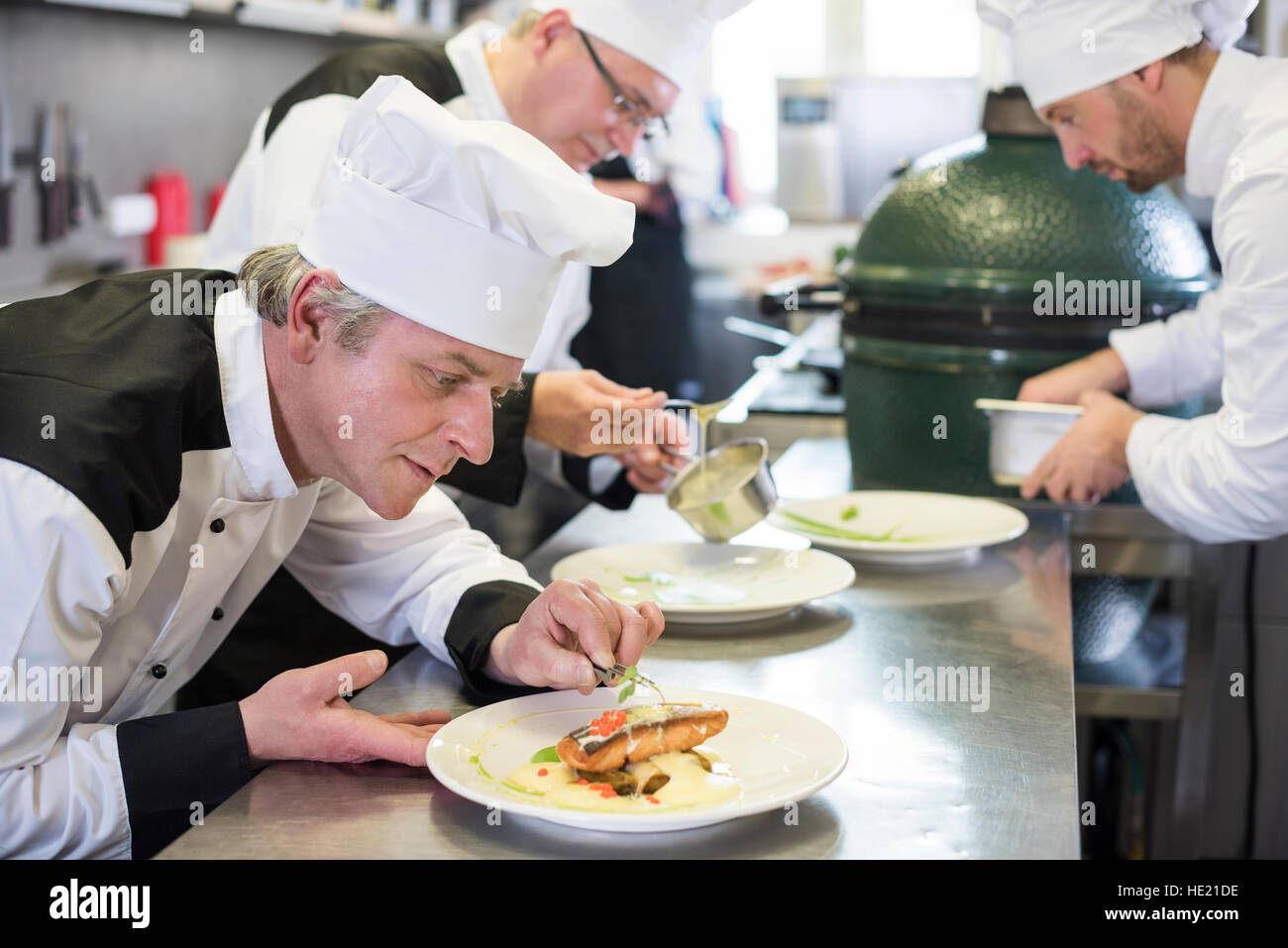 Three best cooks doing their work Stock Photo - Alamy