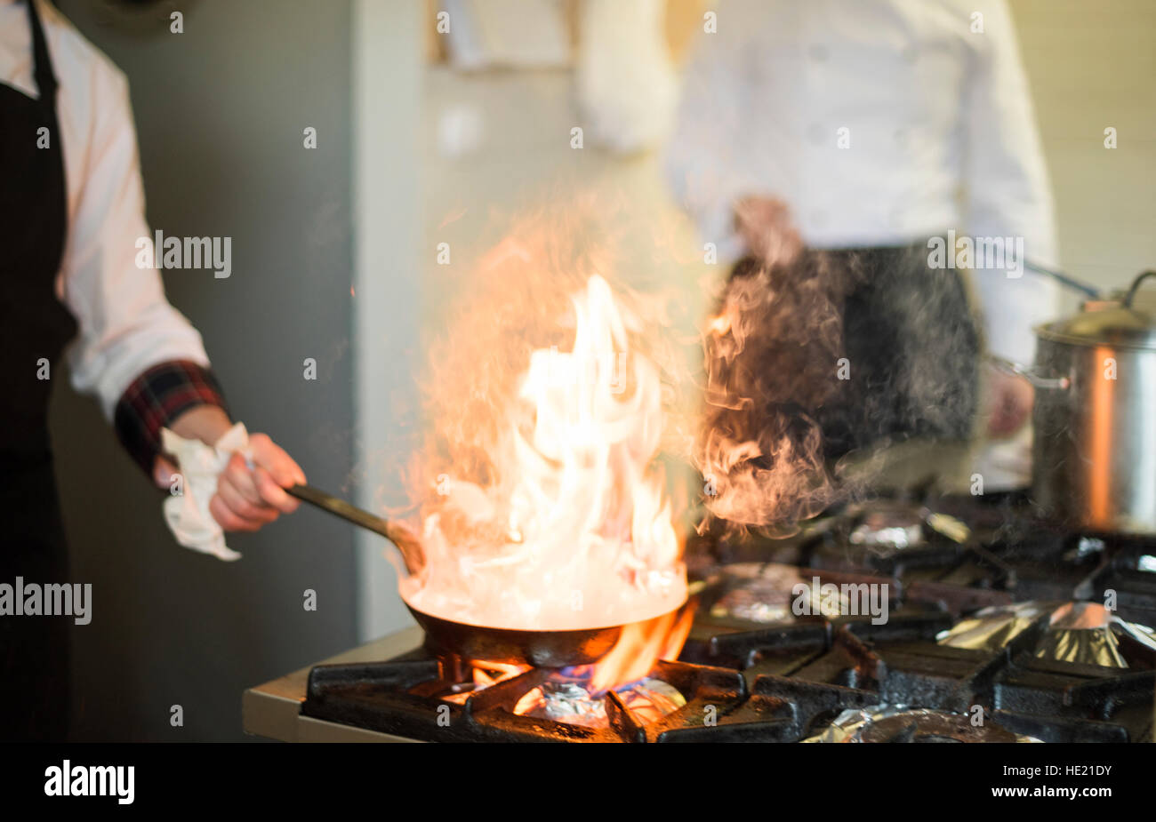 Frying pan is on fire Stock Photo - Alamy