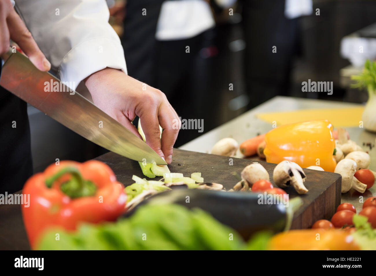Professional cook chopping spring vegetables Stock Photo - Alamy