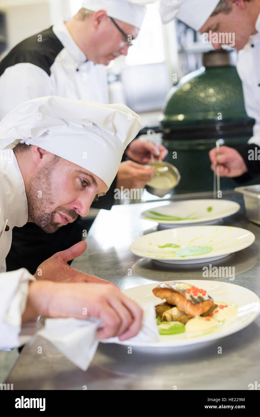 Cook cleaning table before serving it Stock Photo - Alamy