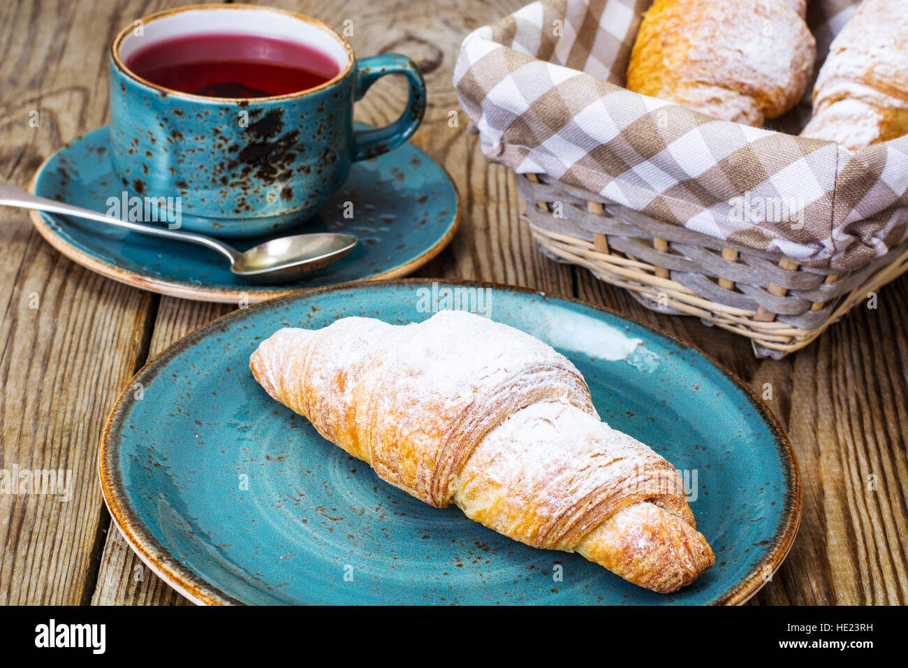 Crispy croissants with tea Stock Photo - Alamy