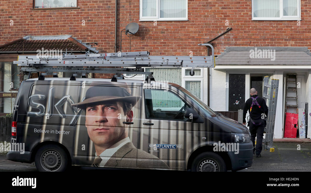 A Sky television engineer installs a satellite dish at an address in ...