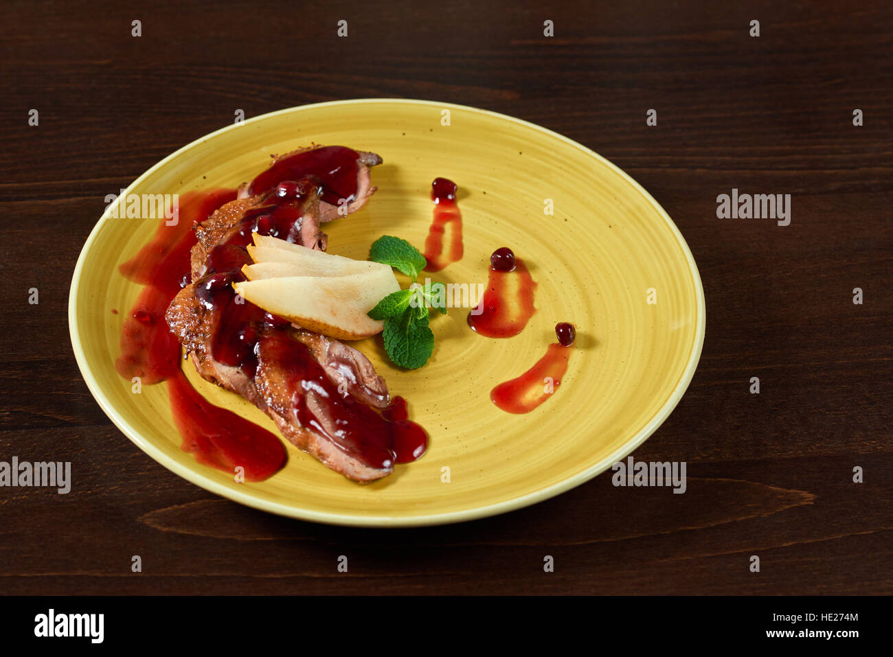 Duck fillet. Roasted duck fillet served with sliced pears at the ...