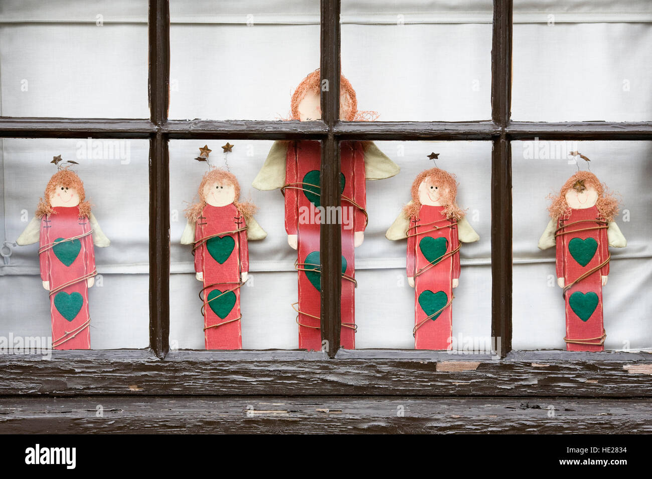 Five angels in the window of a house Stock Photo - Alamy