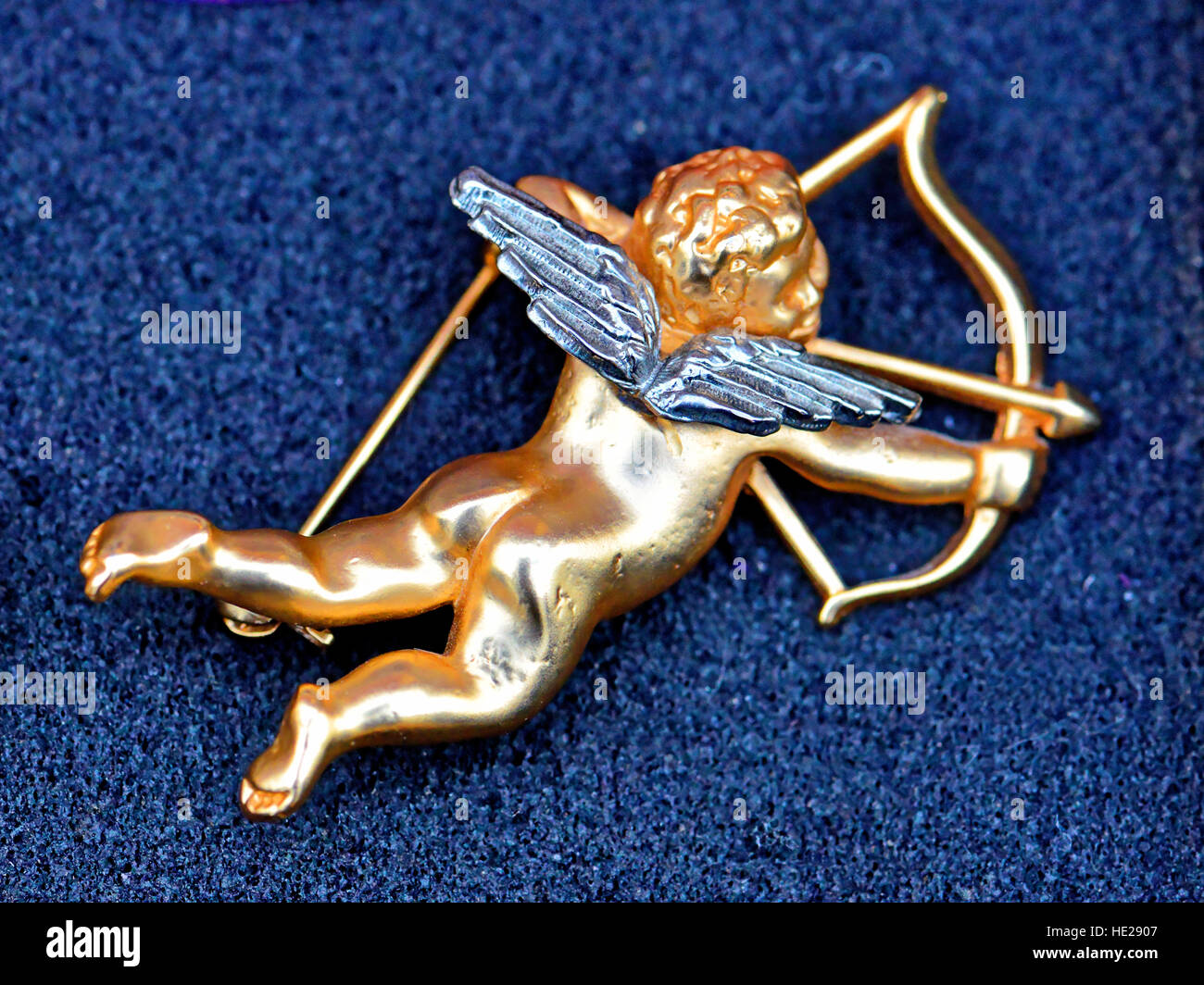 Gold Cherub angel with silver wings bow and arrow brooch Stock Photo ...