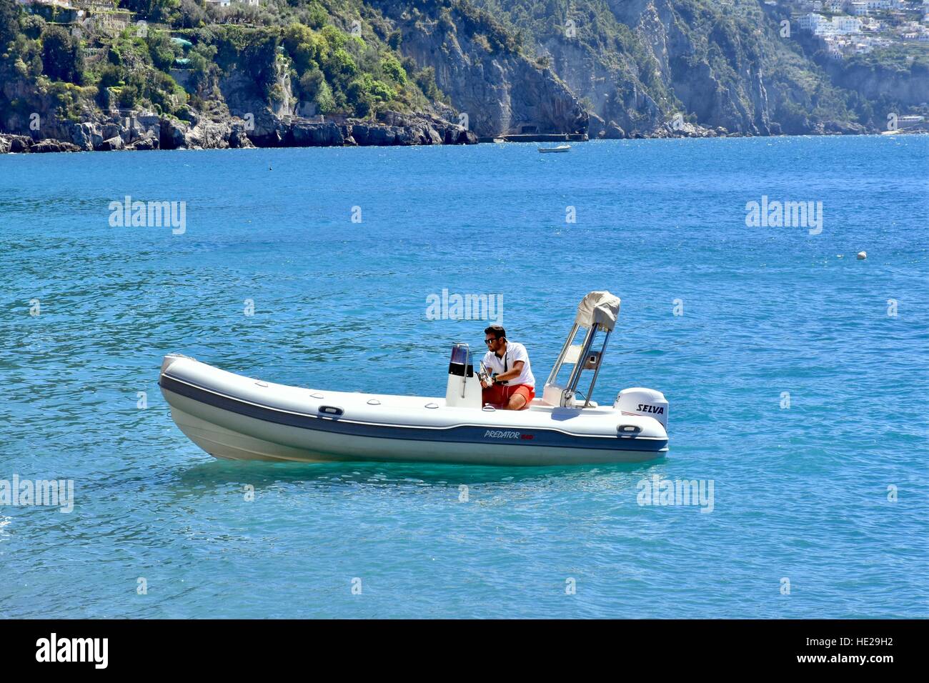 Small boat off the coast of Capri island, Italy Stock Photo - Alamy
