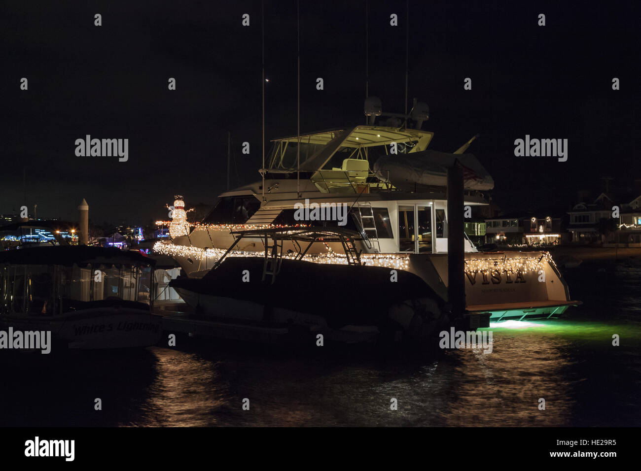 Colorful holiday lights on sailboats and ships in the Balboa Harbor for ...