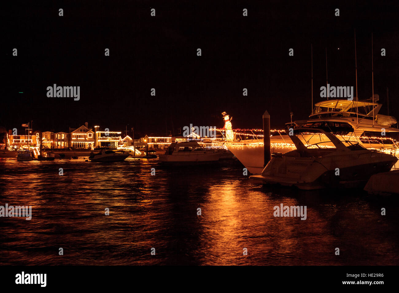 Colorful holiday lights on sailboats and ships in the Balboa Harbor for ...
