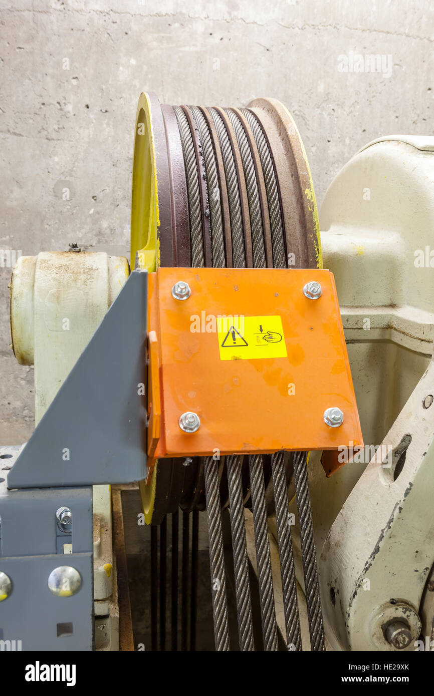 iron cables on a wheel of a motor of the elevator Stock Photo - Alamy