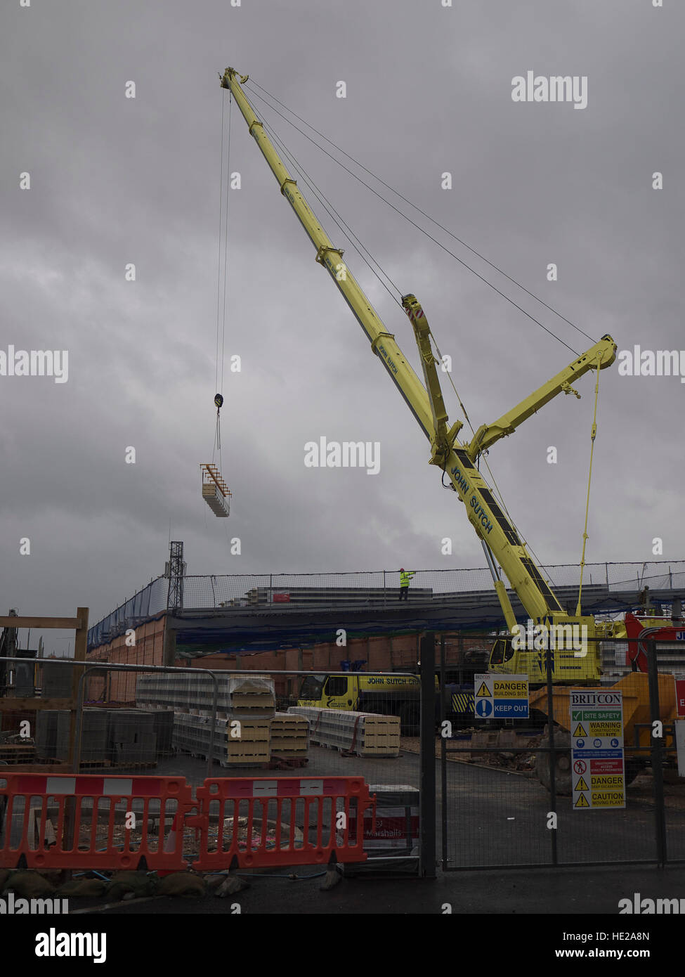 Crane lifting roofing onto a new supermarket Stock Photo - Alamy