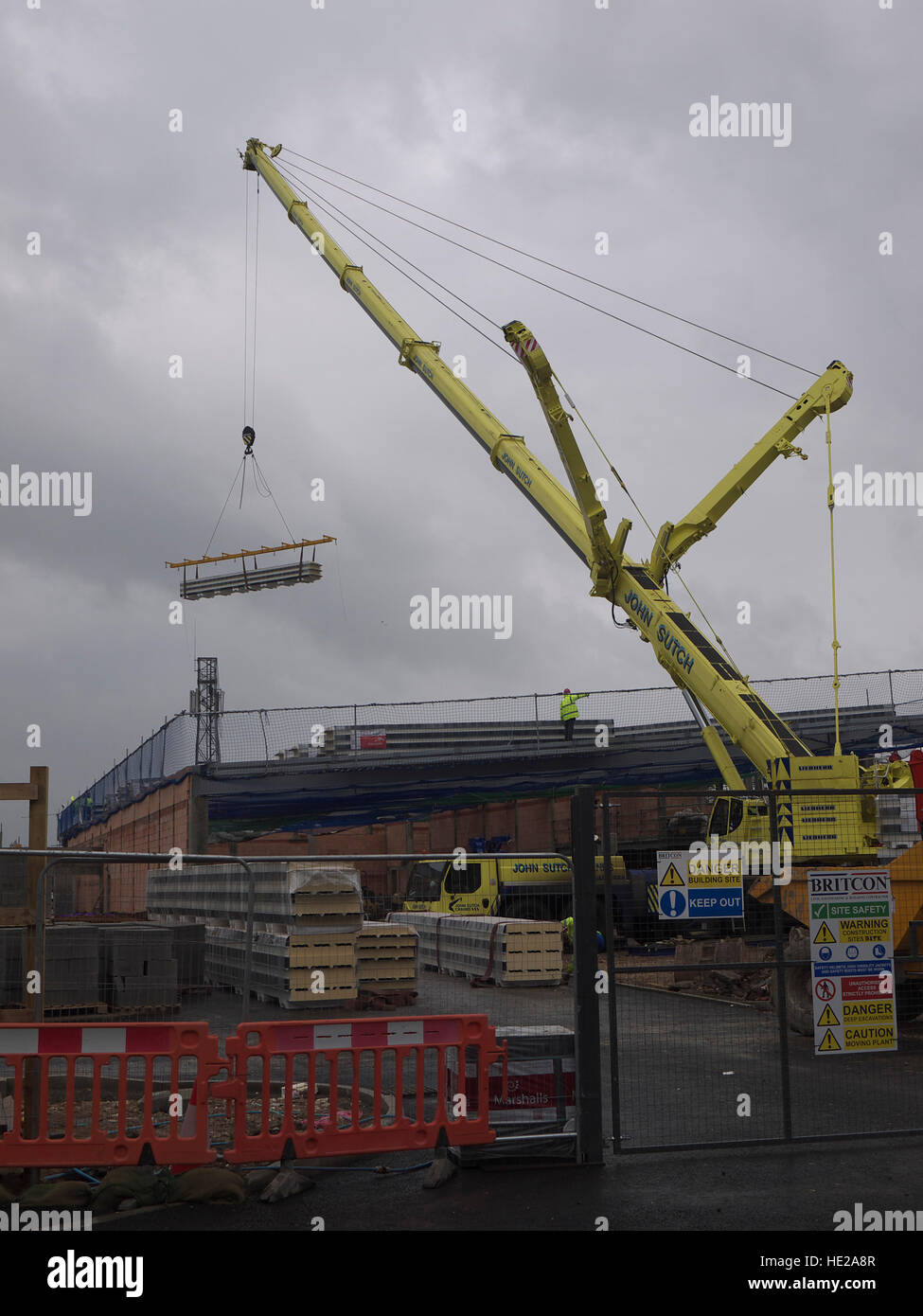 Crane lifting roofing onto a new supermarket Stock Photo - Alamy