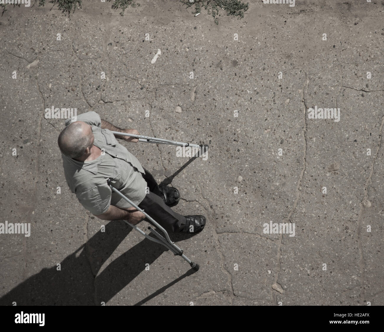 old bold disabled man with a crutchs Stock Photo - Alamy