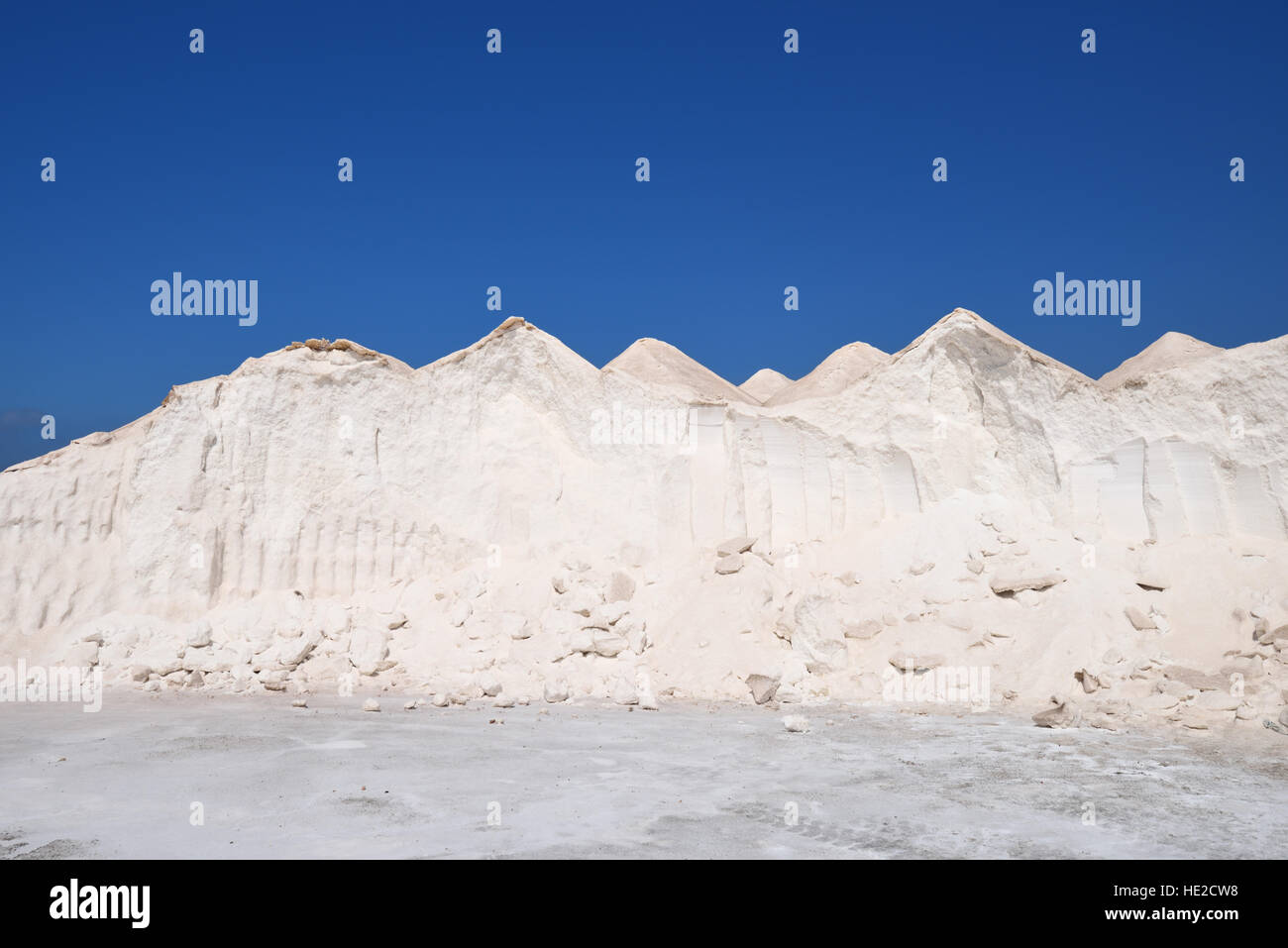 Big piles of white sea salt under a blue sky Stock Photo - Alamy
