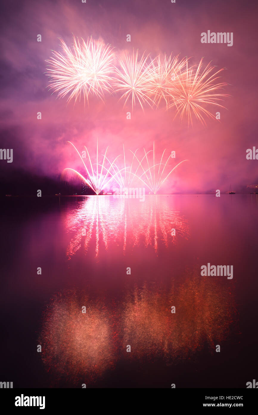 Colorful spectacular fireworks reflecting in water Stock Photo - Alamy