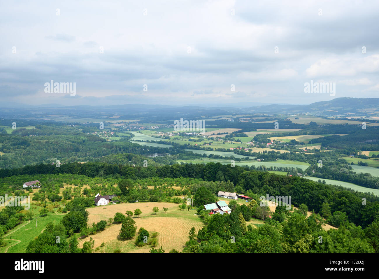 Green landscape with trees, houses and distant hills Stock Photo - Alamy