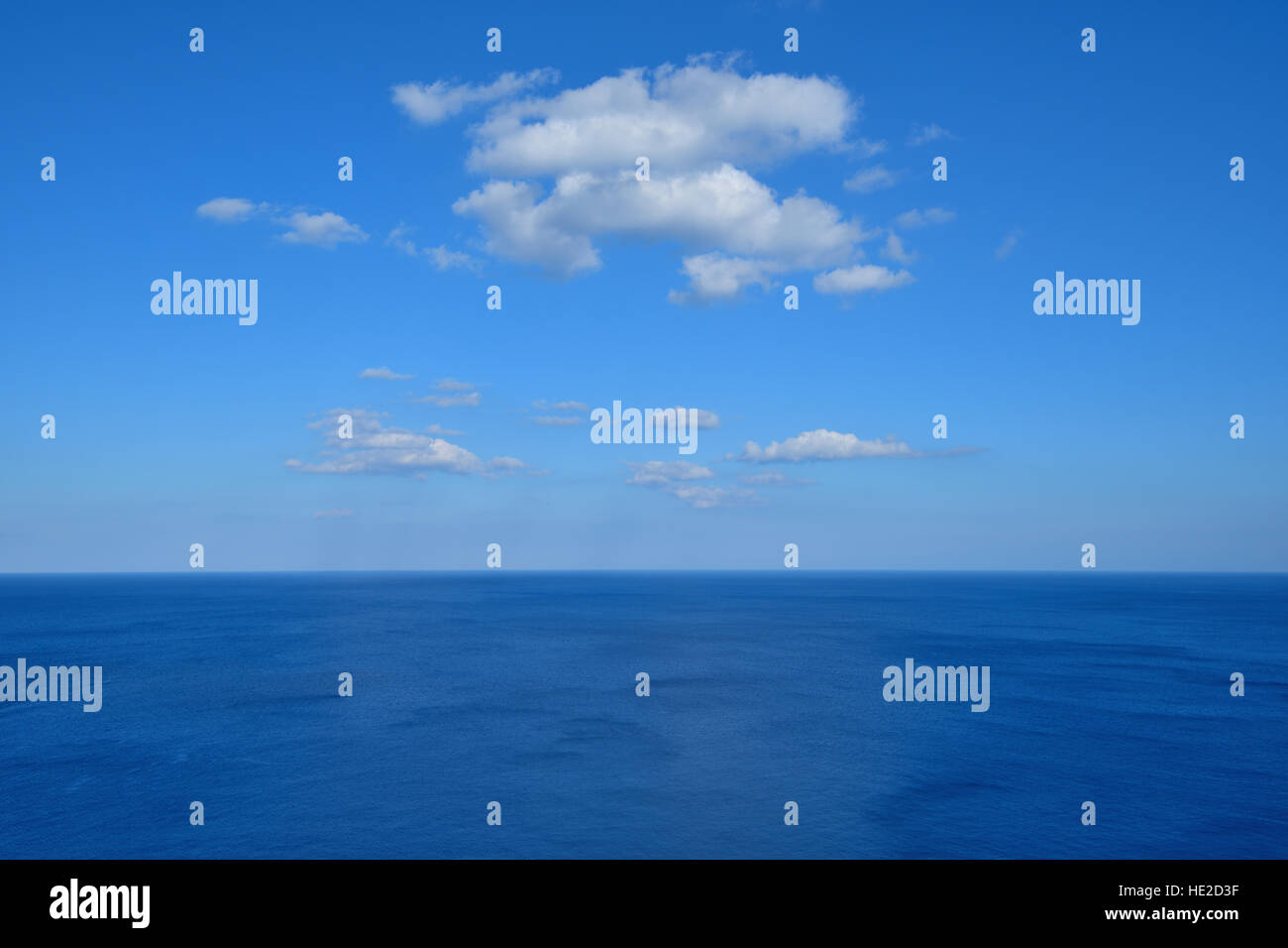 Vast deep blue sea with white clouds Stock Photo - Alamy