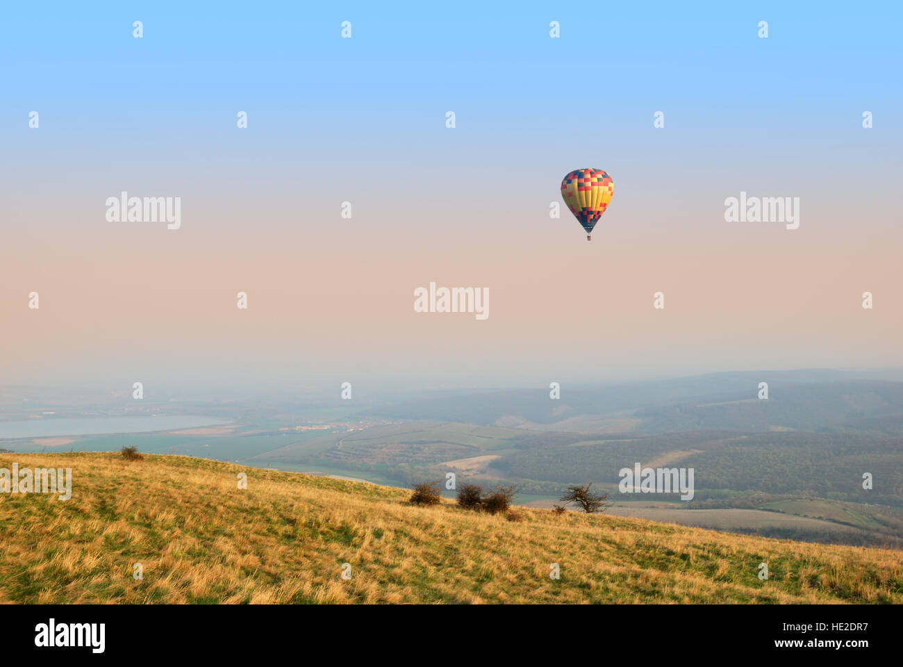 Colorful hot air balloon flying over an autumn landscape Stock Photo ...