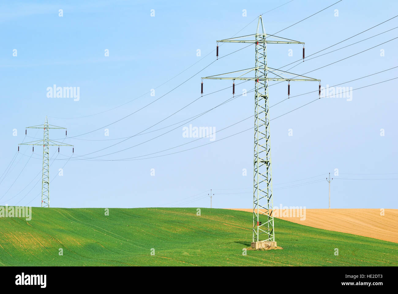 High voltage power lines and countryside fields Stock Photo - Alamy