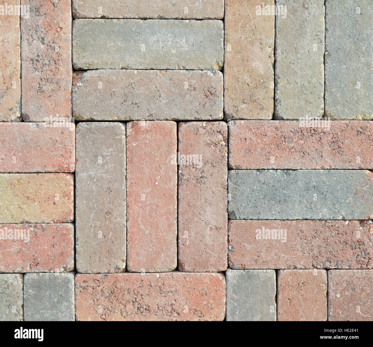 Wall from different colored bricks put together Stock Photo - Alamy