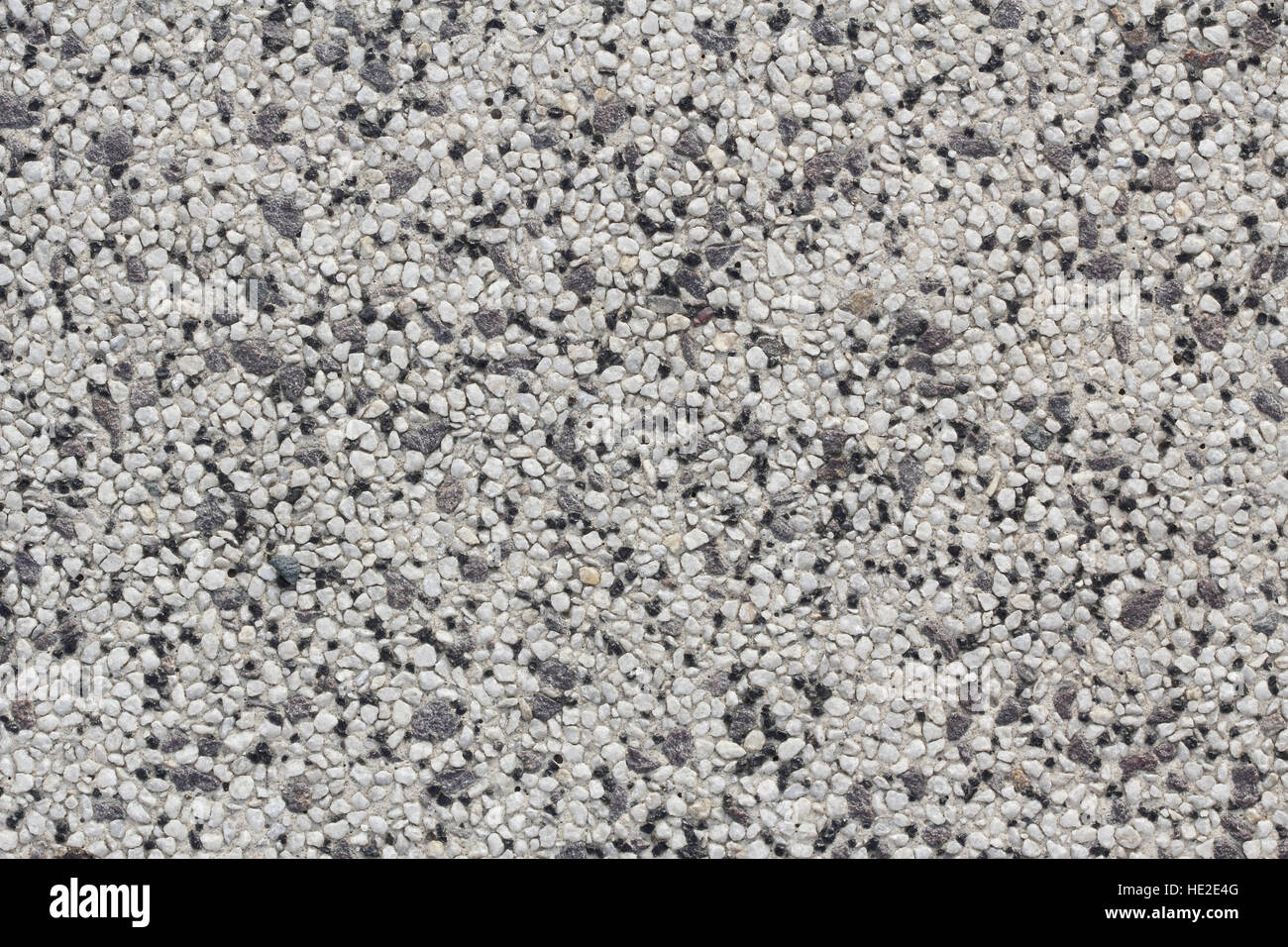 Abstract background paving consisting of small pebbles embedded in ...