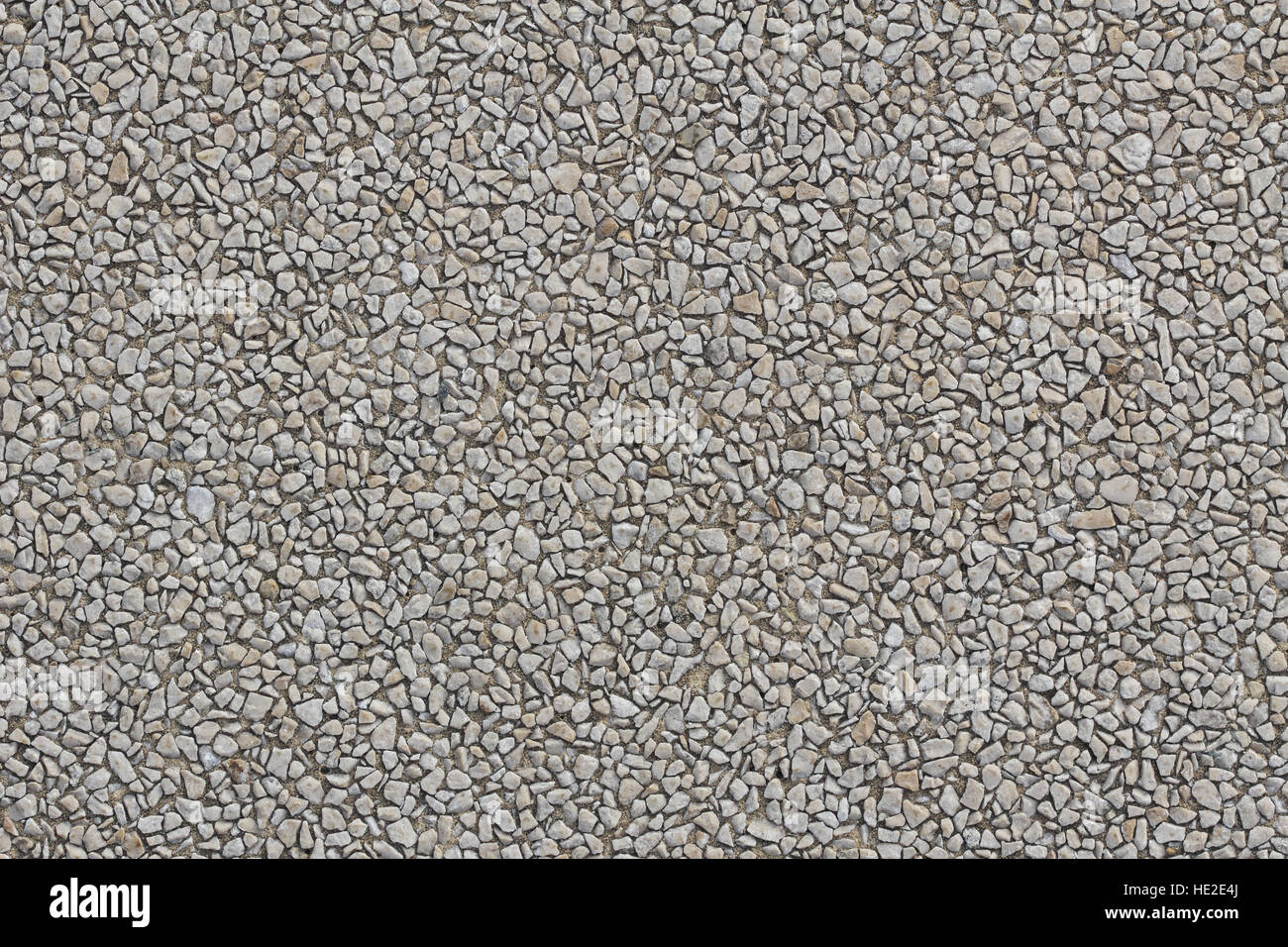 Abstract background paving consisting of small pebbles embedded in ...