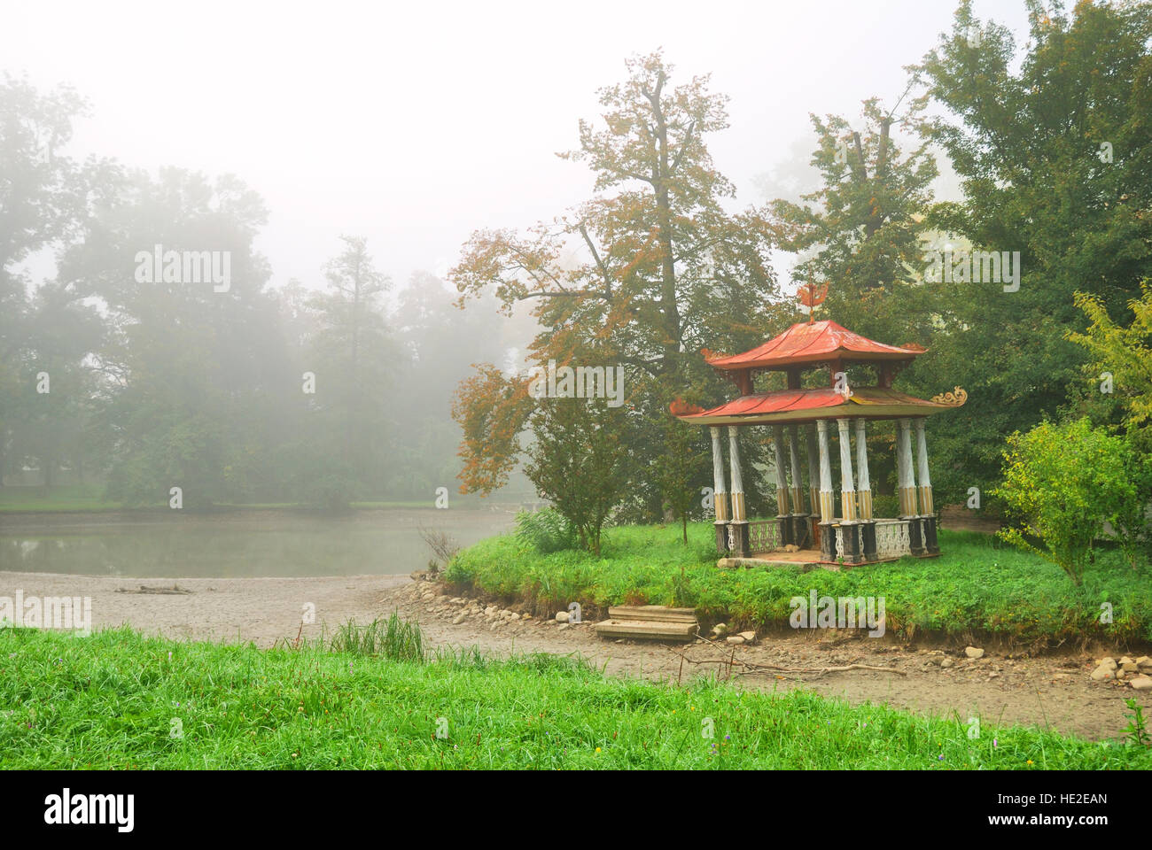 Small eastern arbour on a lake island in a foggy morning Stock Photo ...