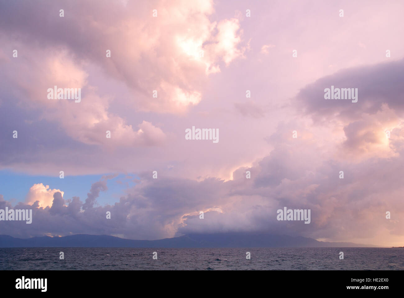 Colorful heavy clouds above land and sea water Stock Photo - Alamy