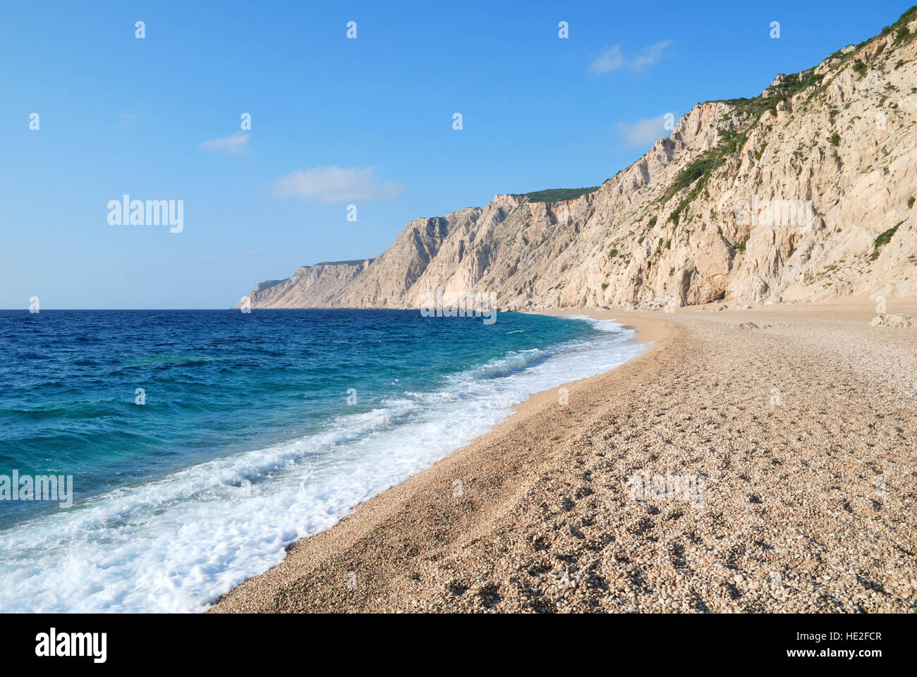 Pebbles Beach and Blue Sea Stock Photo - Alamy