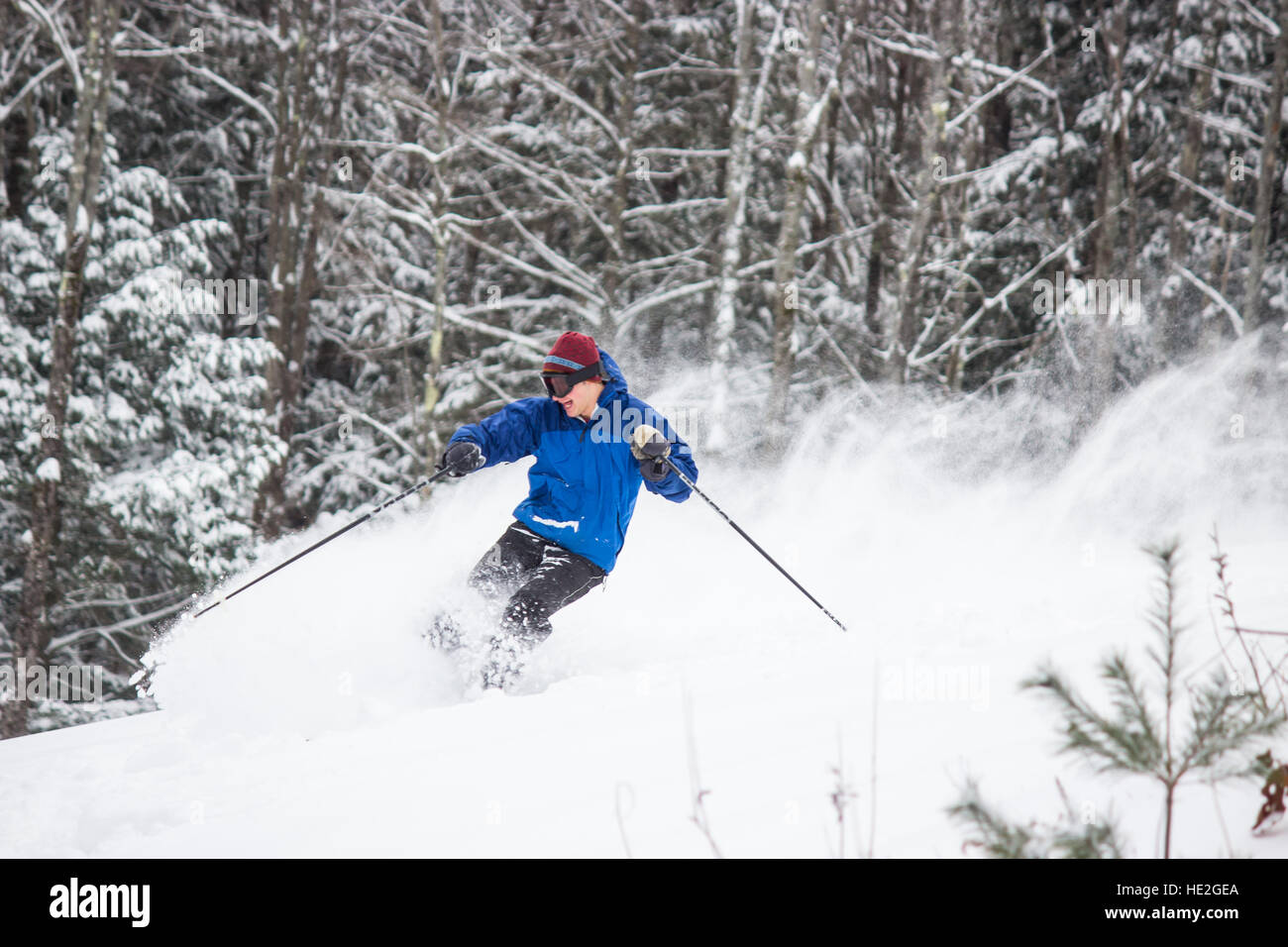 Skiing Teen in Blue Jacket Spraying Powder Stock Photo - Alamy